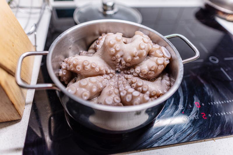 From Above of Whole Raw Octopus Boiling in Pot on Modern Black ...