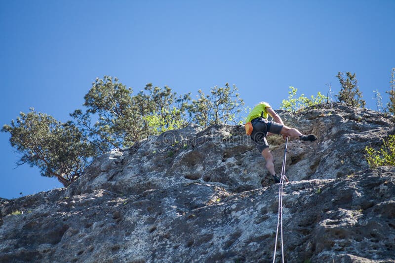 Abseiling from a Rock. Man Comes Down from Peak Editorial Image - Image ...