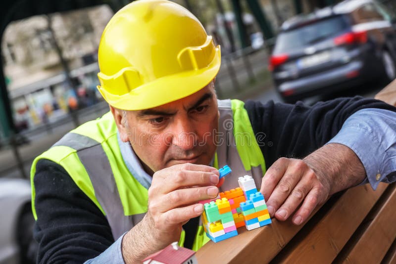 Construction Worker Using Colourful Toy Bricks Stock Image - Image of ...