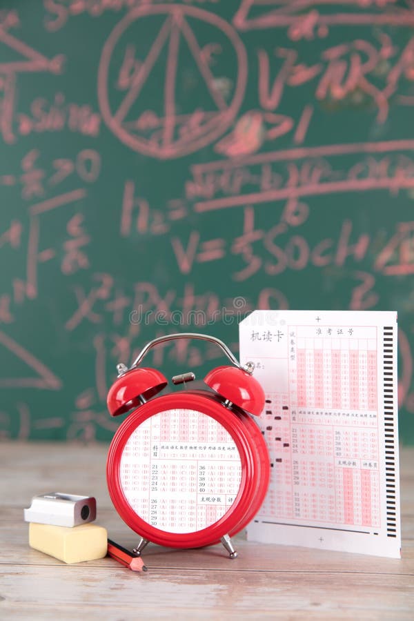 Abstract Alarm Clock and Test Answer Card in Front of Blackboard Stock ...