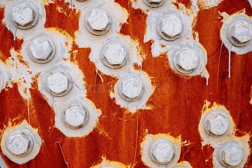 Abstract Background of Bolts and Nuts Painted White on a Red Background ...