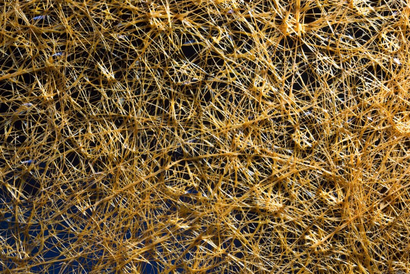 Abstract Background of Yellow Plastic Threads on a Dark Background ...