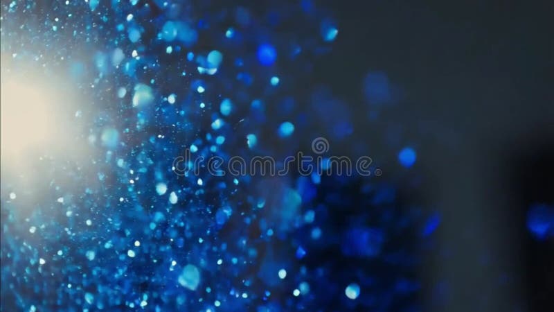Blue Glitter Particles Falling in Light Rays Background Stock Footage ...