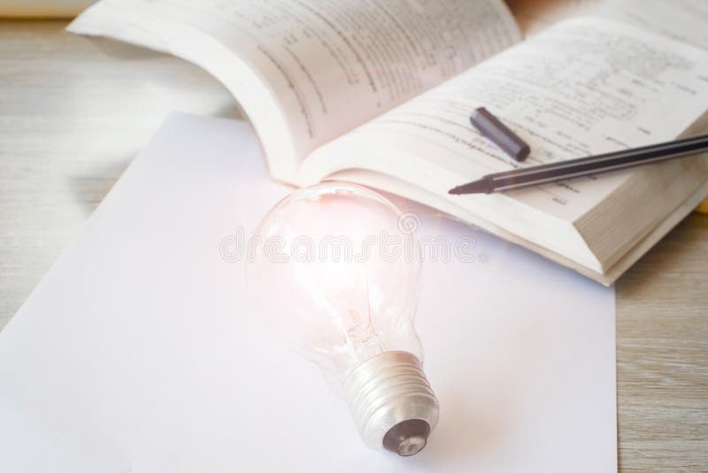 Abstract Concept Study and Educational Equipment. Light Bulb and Book ...