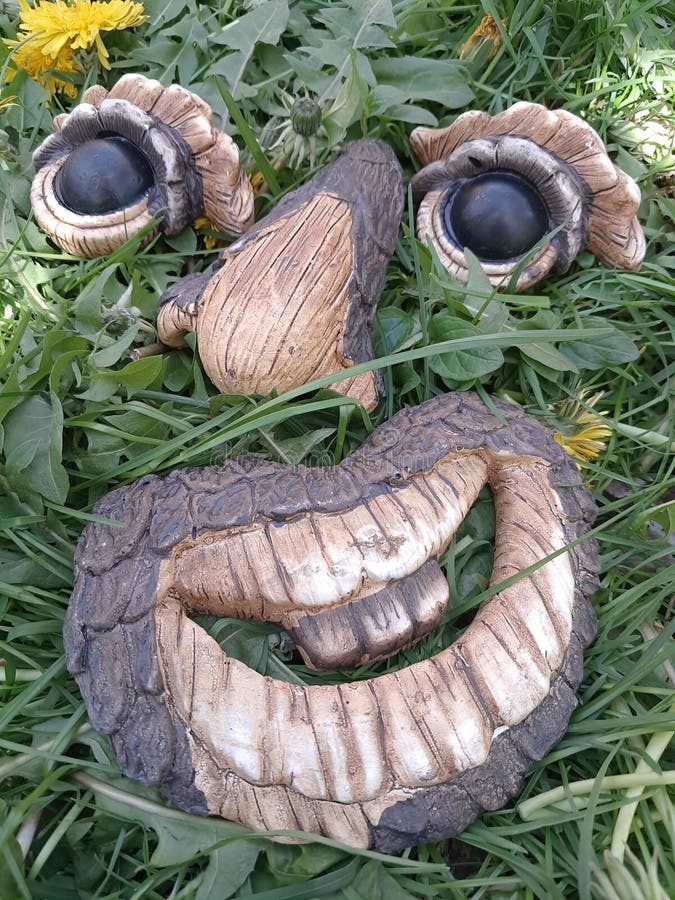 Abstract face in the grass stock image. Image of sculpture - 317338393