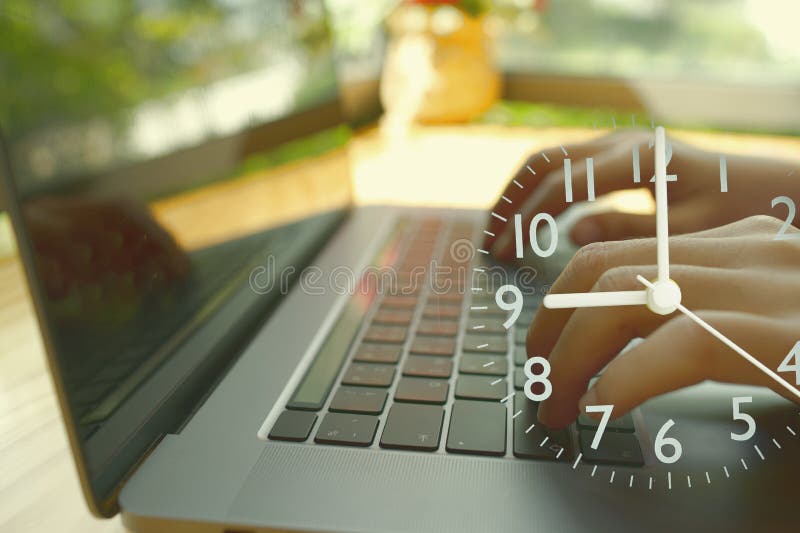 An Abstract Hand Typing a Laptop and an Analog Clock Showing the Start ...