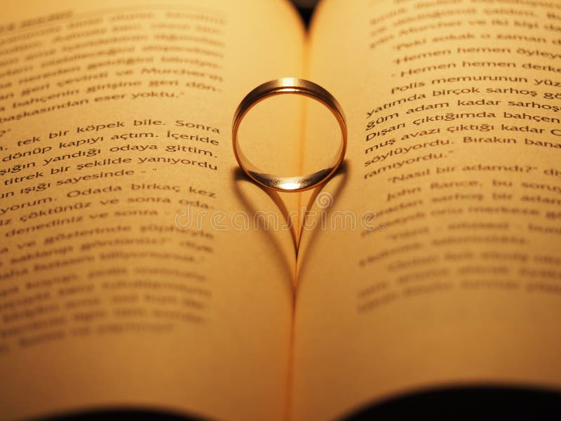 Abstract Heart Shape Shadow of Wedding Ring on a Book. Stock Image ...