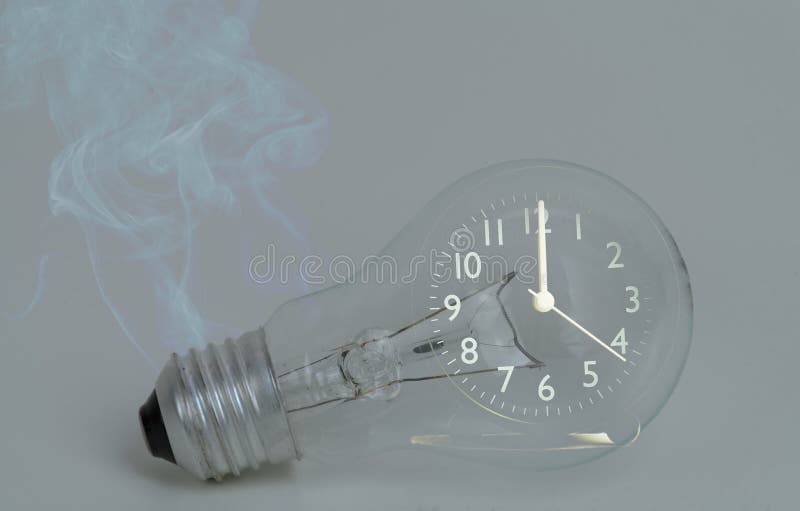Abstract a Light Bulb with Soot from Working and a Black Analog Clock ...