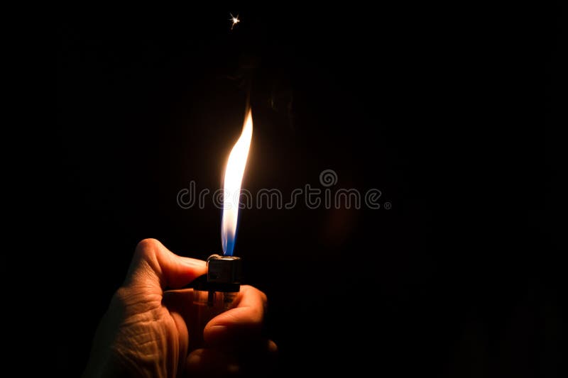 Abstract Motion Hand with Lighter Igniting Sparks on Dark Background ...