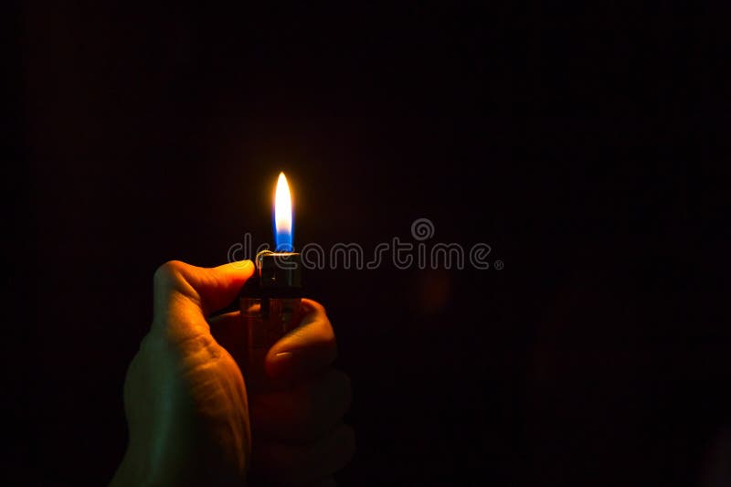 Abstract Motion Hand with Lighter Igniting Sparks on Dark Background ...