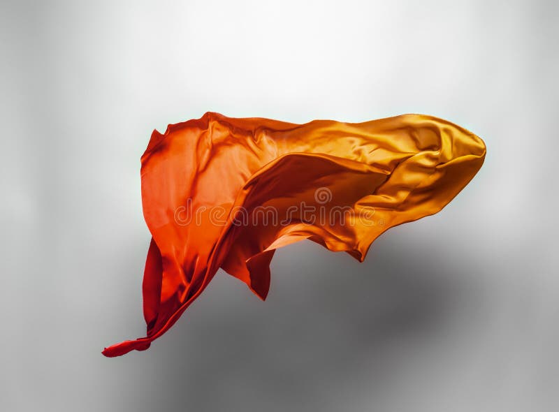 Orange flying fabric stock image. Image of golden, action - 100306163