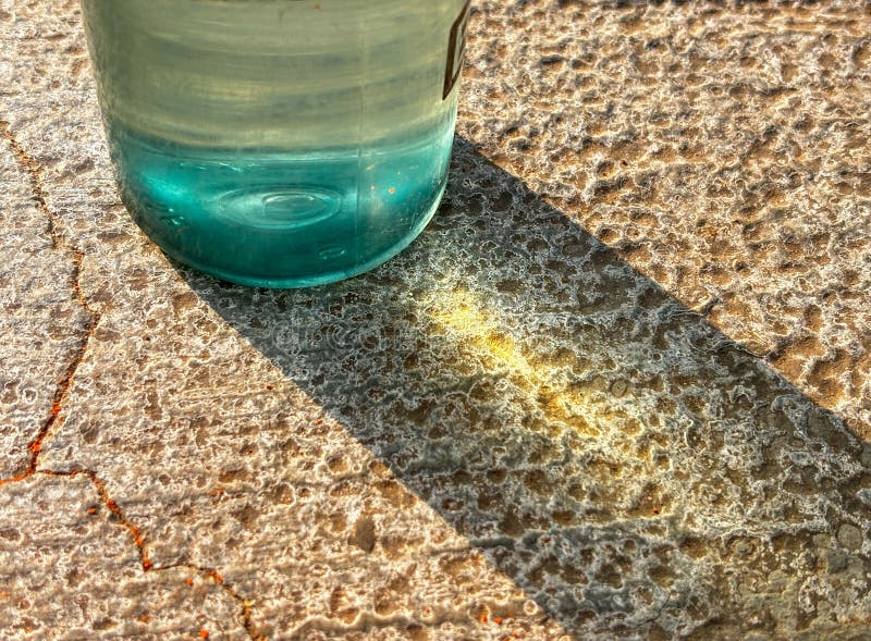 An Abstract Photo with Glass Bottle Place on Rough Textured Surface ...