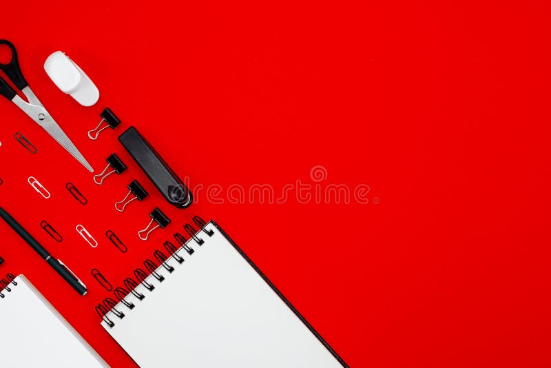 Abstract Red Table with Stationary . Blank Notebook and Scissors ...