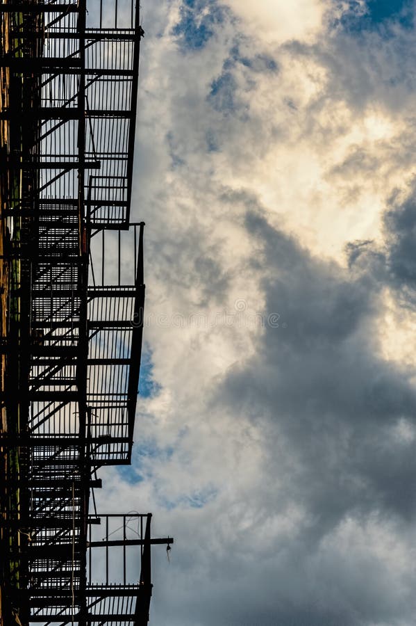 Abstract Fire Escape Silhouette and Cloudy Skies Stock Image - Image of ...