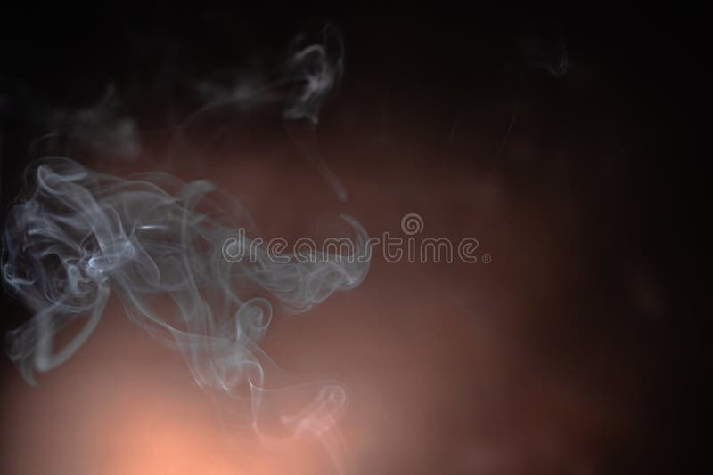 Abstract Smoke from Incense and Light in a Black Background Stock Photo ...