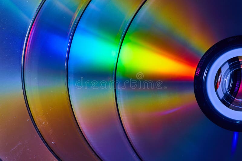 Abstract Stack of Four Silvery CDs with Reflective Rainbow Bursts of ...