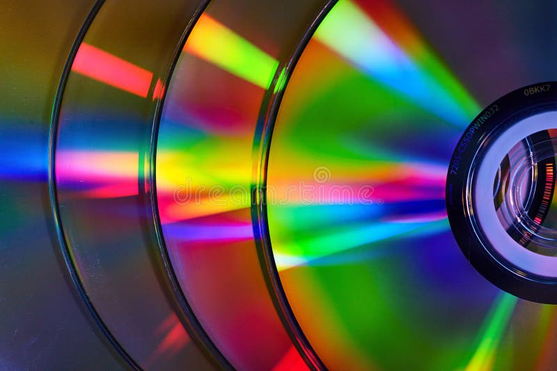 Abstract Stack of Four Silvery CDs with Reflective Rainbow Colored ...