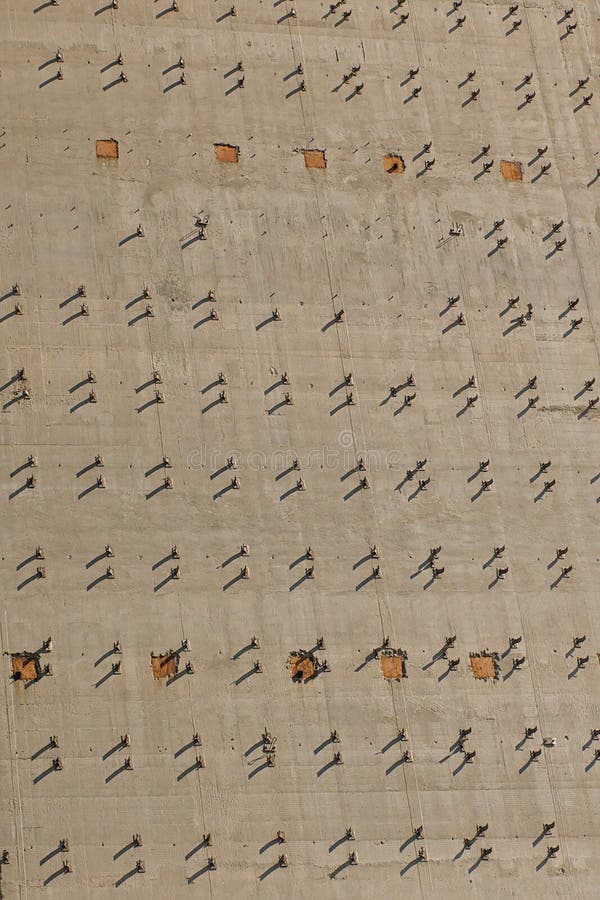 Abstract View of a Concrete Wall with a Grid of Metallic Brackets ...