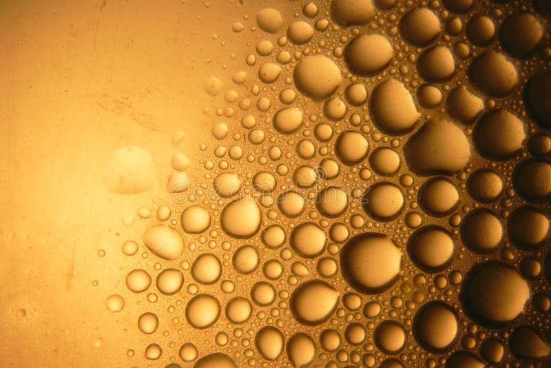 Golden Amber Water Drops stock image. Image of drink, shape - 4683827