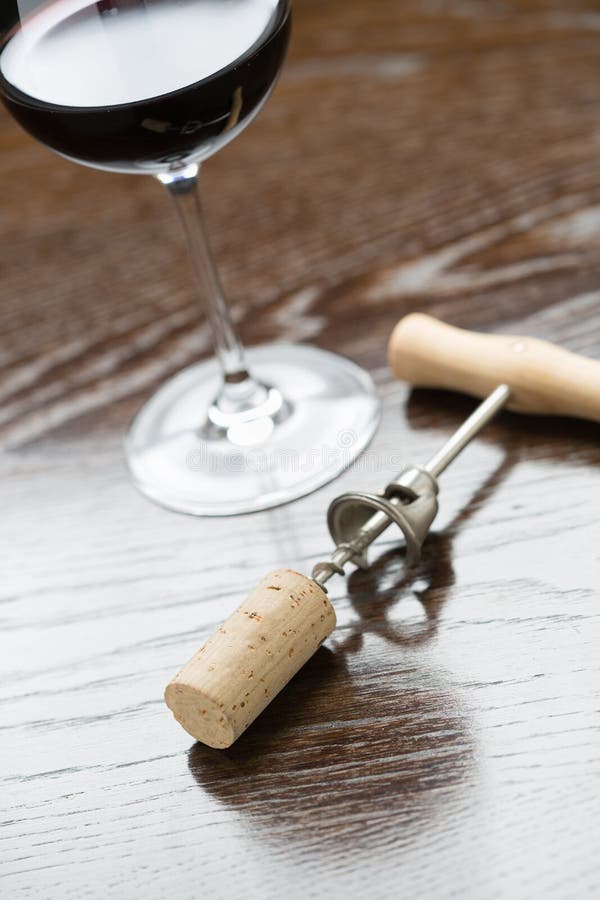 Abstract Wine Glass, Cork and Corkscrew Laying on a Reflective Wood ...