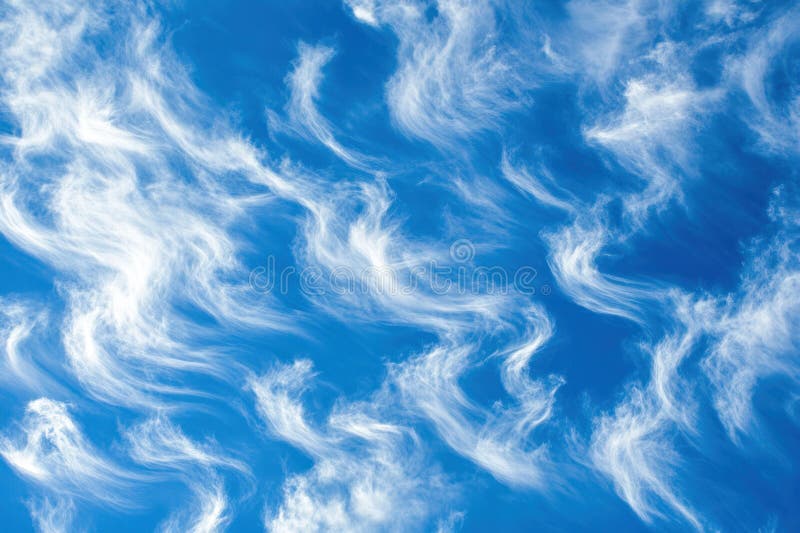 Abstract Wispy White Clouds Swirling Across a Bright Blue Sky Stock ...