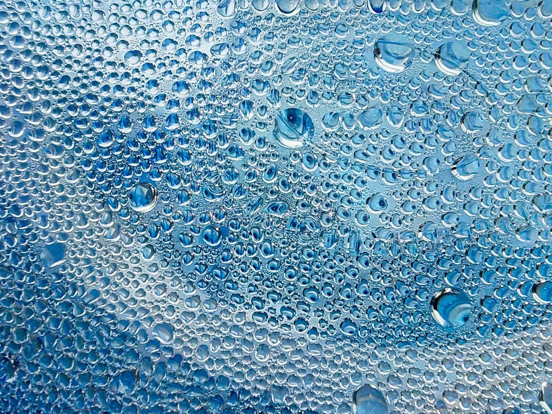 An Abstraction. Drops of Water, Dew, on the Blue Glass Stock Photo ...