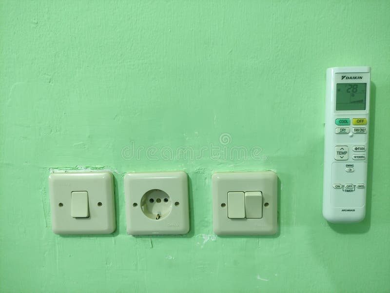AC Remote, Socket and Switch on the Wall Stock Photo - Image of yellow ...