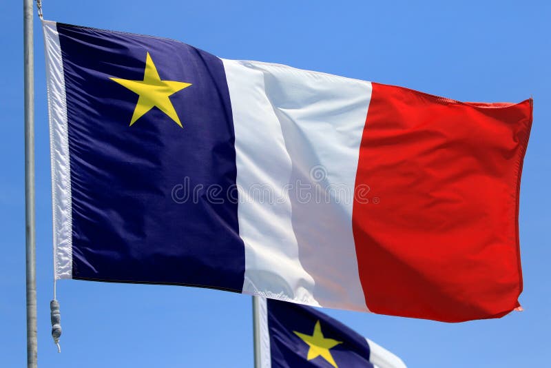 Acadian Flag with Blue Sky Background Stock Photo - Image of canadian ...