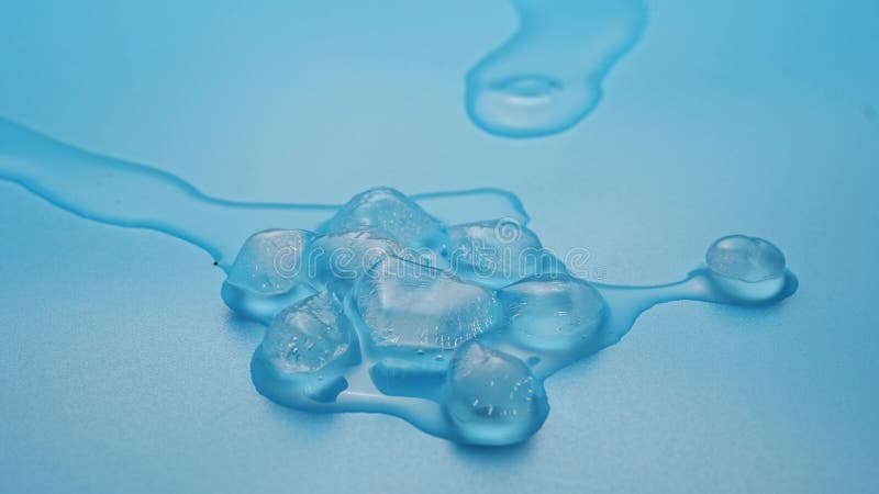 Accelerated Shooting. the Process of Melting Ice Cubes on a Blue ...