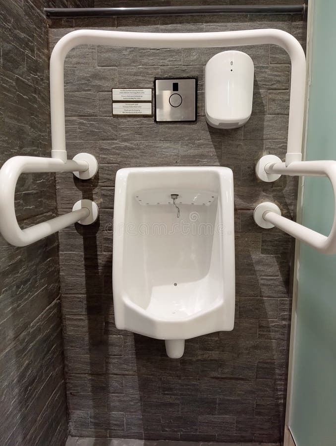 Accessible Comfort: Urinal with Grab Bars and Push-Button Stock Photo ...