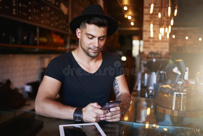 Accessing the Best Cafe Management Apps Right from His Phone. a Young ...