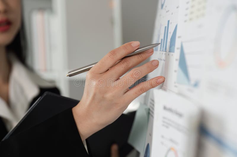 Accountant Analyzing Financial Data on a Wall Chart, Emphasizing Key ...
