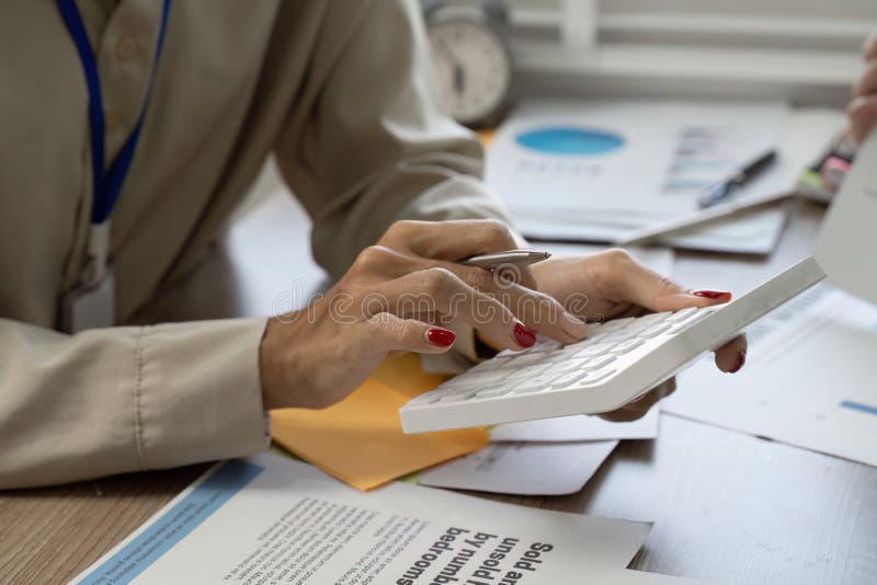Accountant Calculating Financial Figures with a Calculator and ...