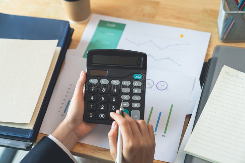 Accountant Using Calculator with Financial Documents on Desk Office ...