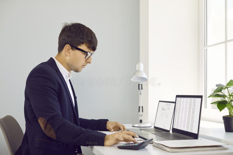 Accountant Using Calculator and Working with Digital Business Documents ...