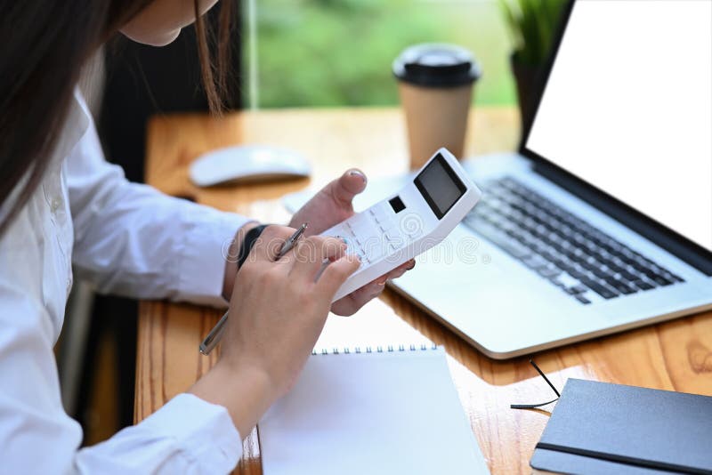 Accountant Working with Laptop and Using Calculator in Office Room ...