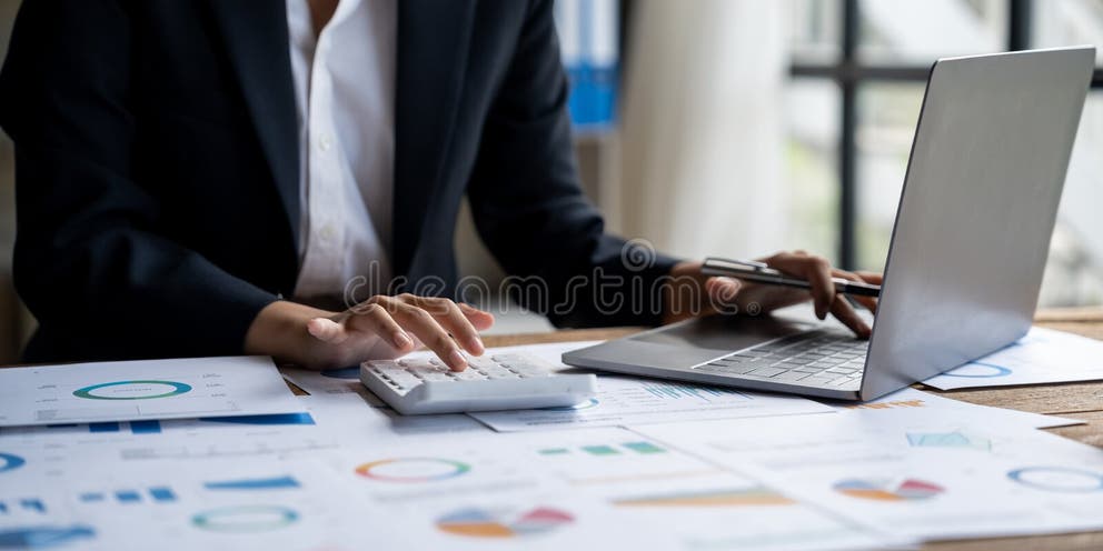 Accountants Work Analyzing Financial Reports on a Laptop at His Office ...