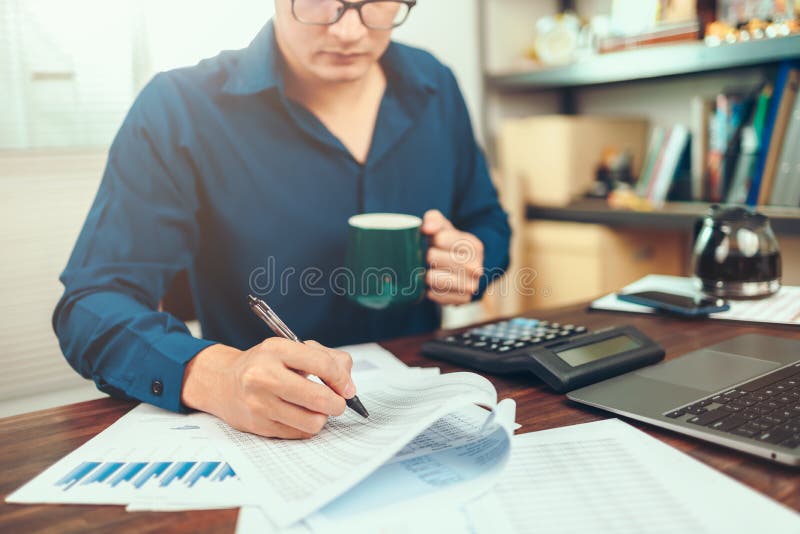 Accounting Woking with Data Sheet on the Office Desk. Calculator with ...