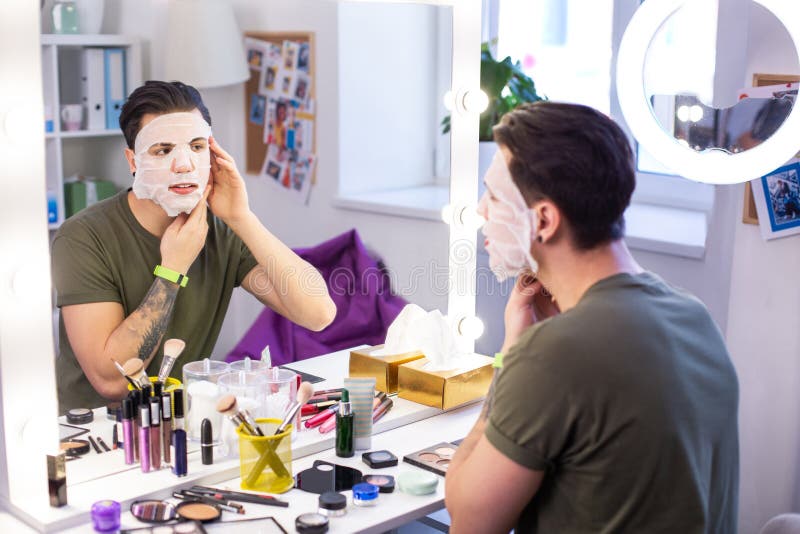 Accurate Man Correcting His Smoothing Face Mask while Getting Ready ...