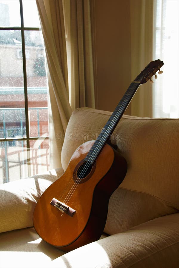 Acoustic Guitar on an Armchair Next To the Window. Stock Image - Image ...