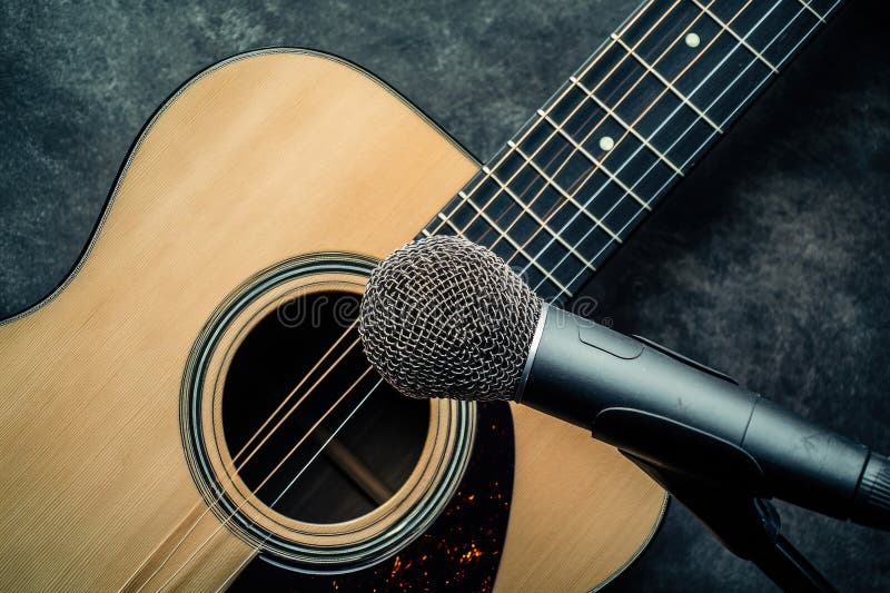 An Acoustic Guitar Features a Microphone that is Attached To it Stock ...