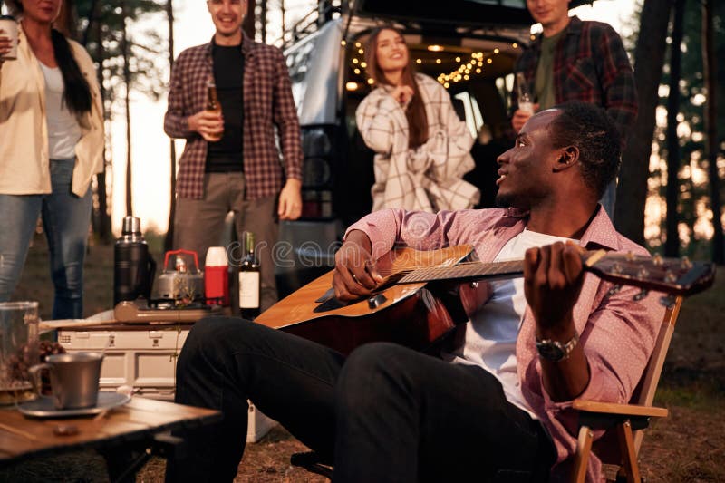 Acoustic Guitar Player. Group of Friends are Together in the Forest ...