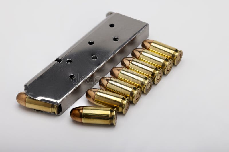 .45 ACP Bullets and Gun Magazine on White Background Stock Image ...