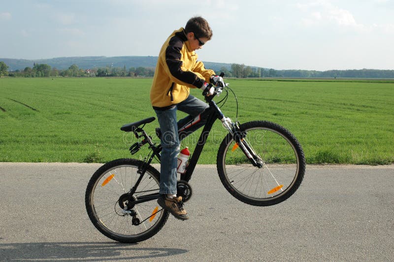Acrobat on bicycle stock photo. Image of acrobatic, green - 4771106
