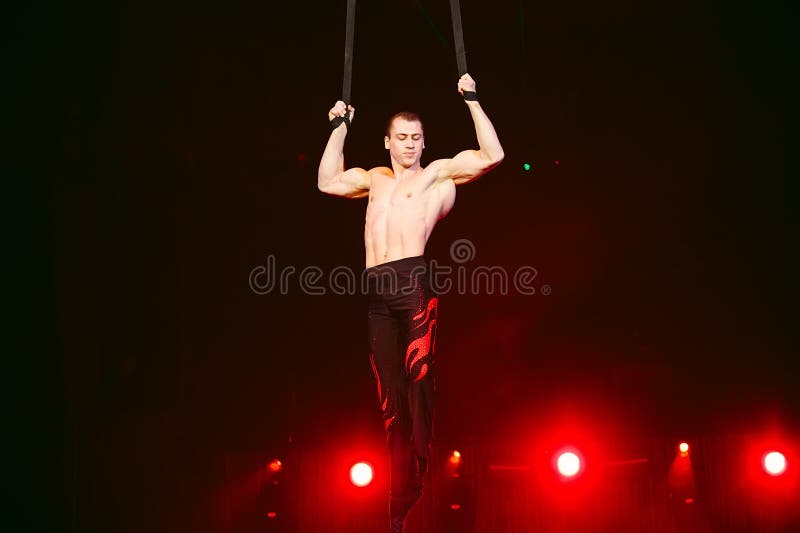 Acrobat Performs a Difficult Trick in the Circus. Stock Photo - Image ...