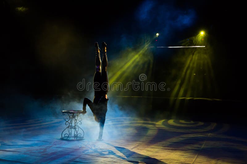 Acrobat Performs a Difficult Trick in the Circus. Editorial Photo ...