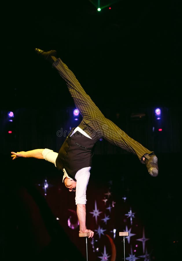 Acrobat Performs a Difficult Trick in the Circus. Stock Photo - Image ...