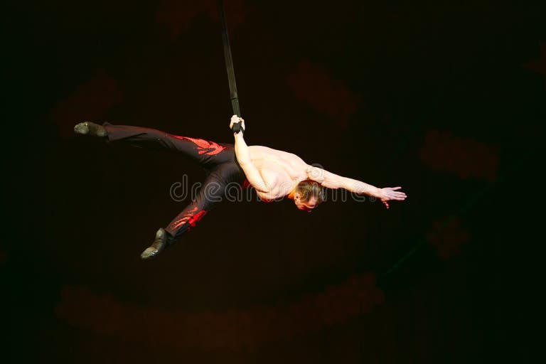 Acrobat Performs a Difficult Trick in the Circus. Stock Photo - Image ...