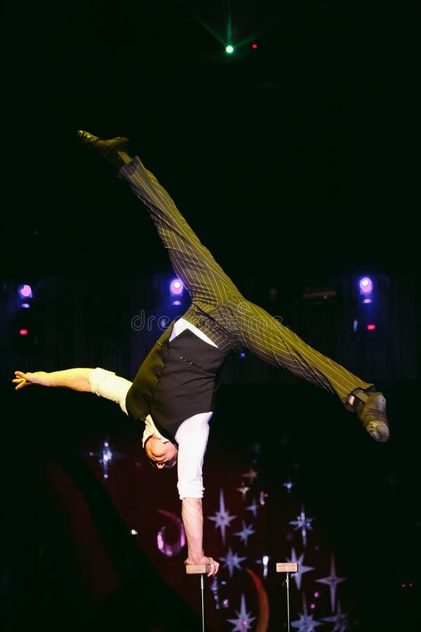 Acrobat Performs a Difficult Trick in the Circus. Stock Photo - Image ...