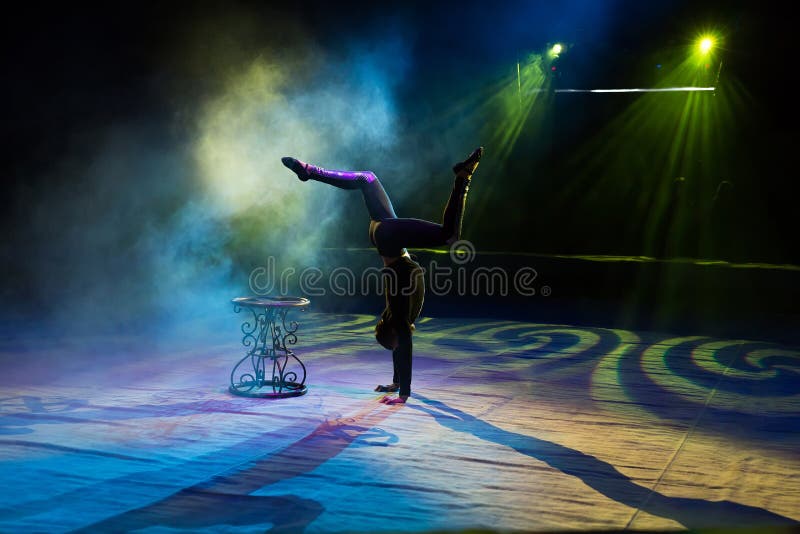 Acrobat Performs a Difficult Trick in the Circus. Editorial Photo ...